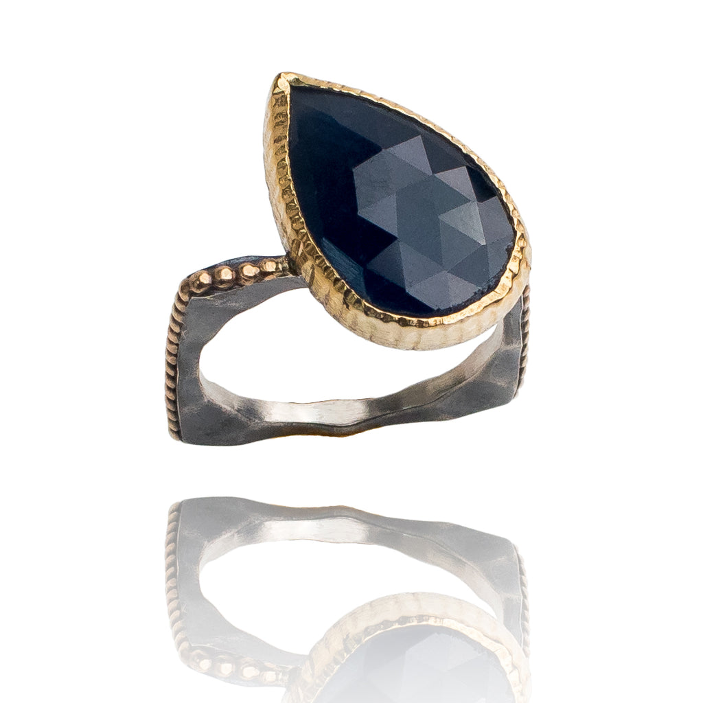 Sapphire pear shaped set in 18k yellow gold. Beaded band, oxidized sil ...